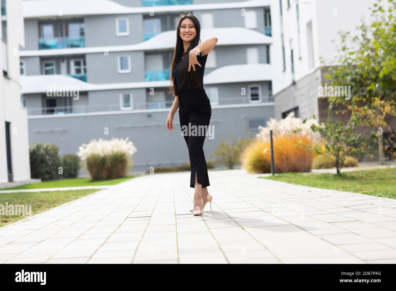 Woman with high heels outside in front of new buildings Stock Photo - Alamy