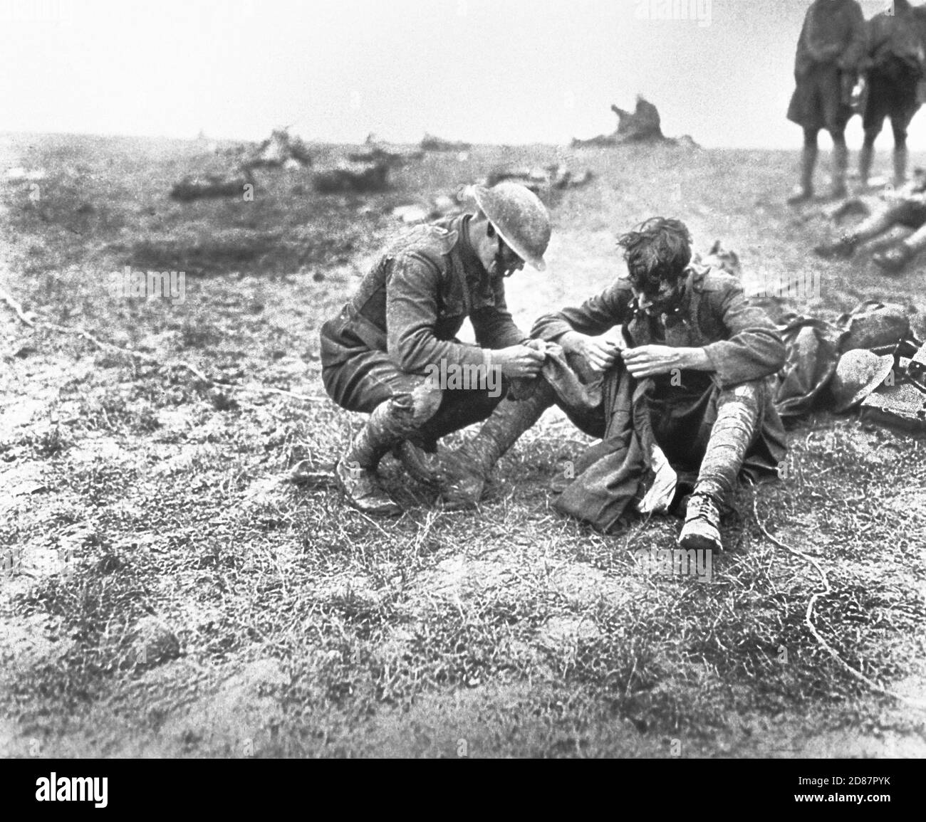 Close-up of Two Soldiers in Uniform sitting on ground examining ...