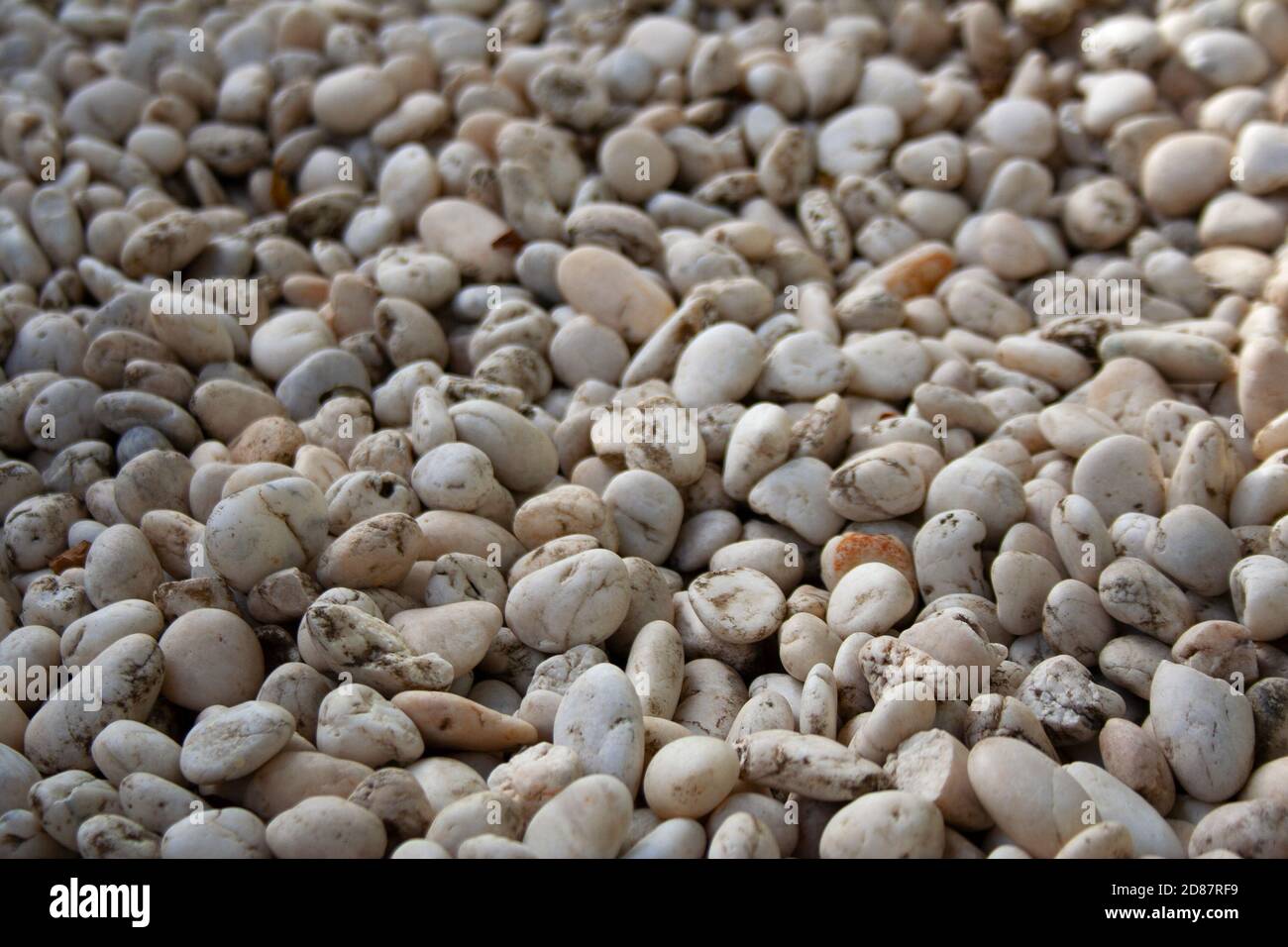 Light pebble stones textured background Stock Photo - Alamy