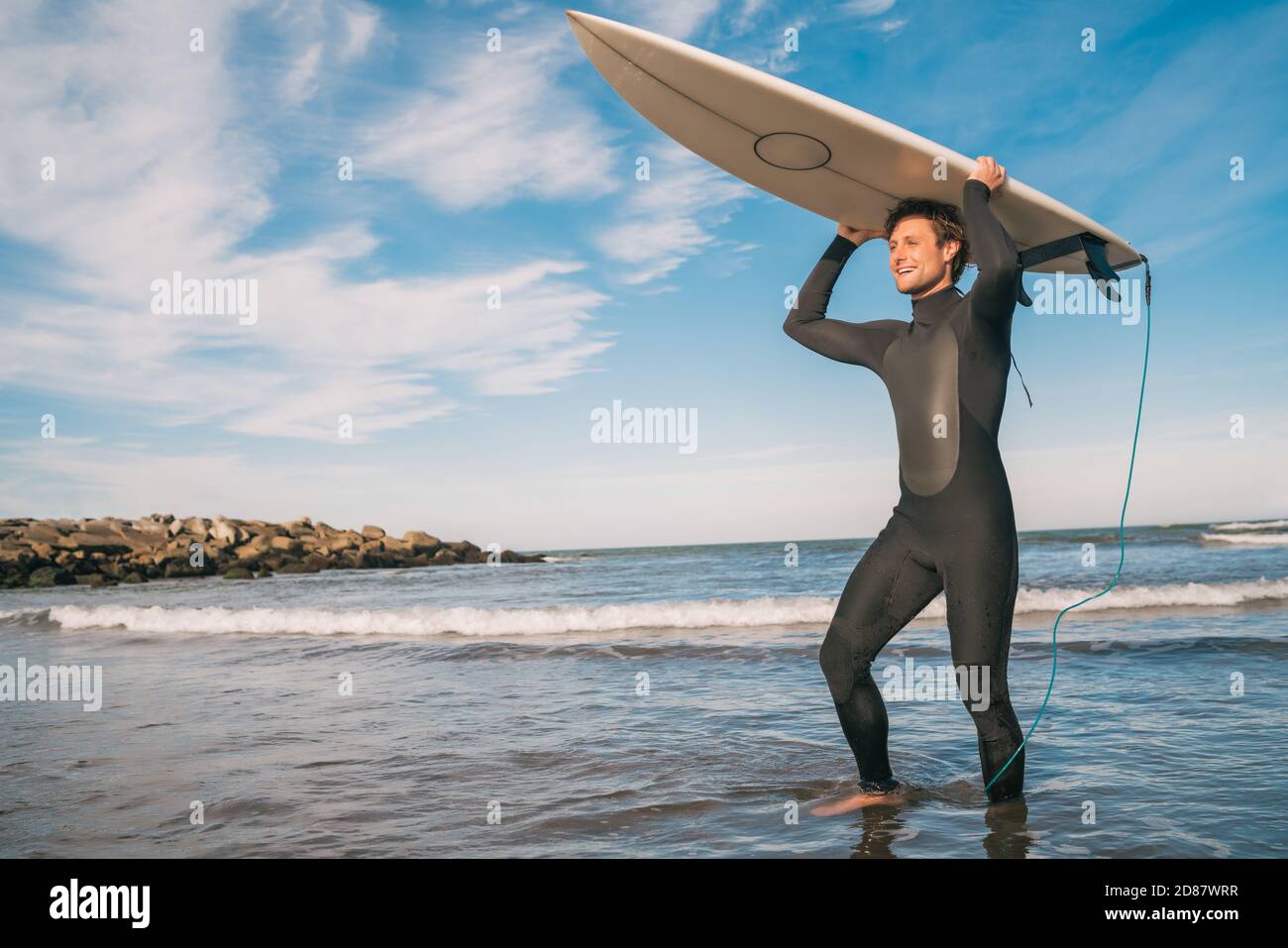 Surfer surf entering water man male holding surfboard waves hi-res ...
