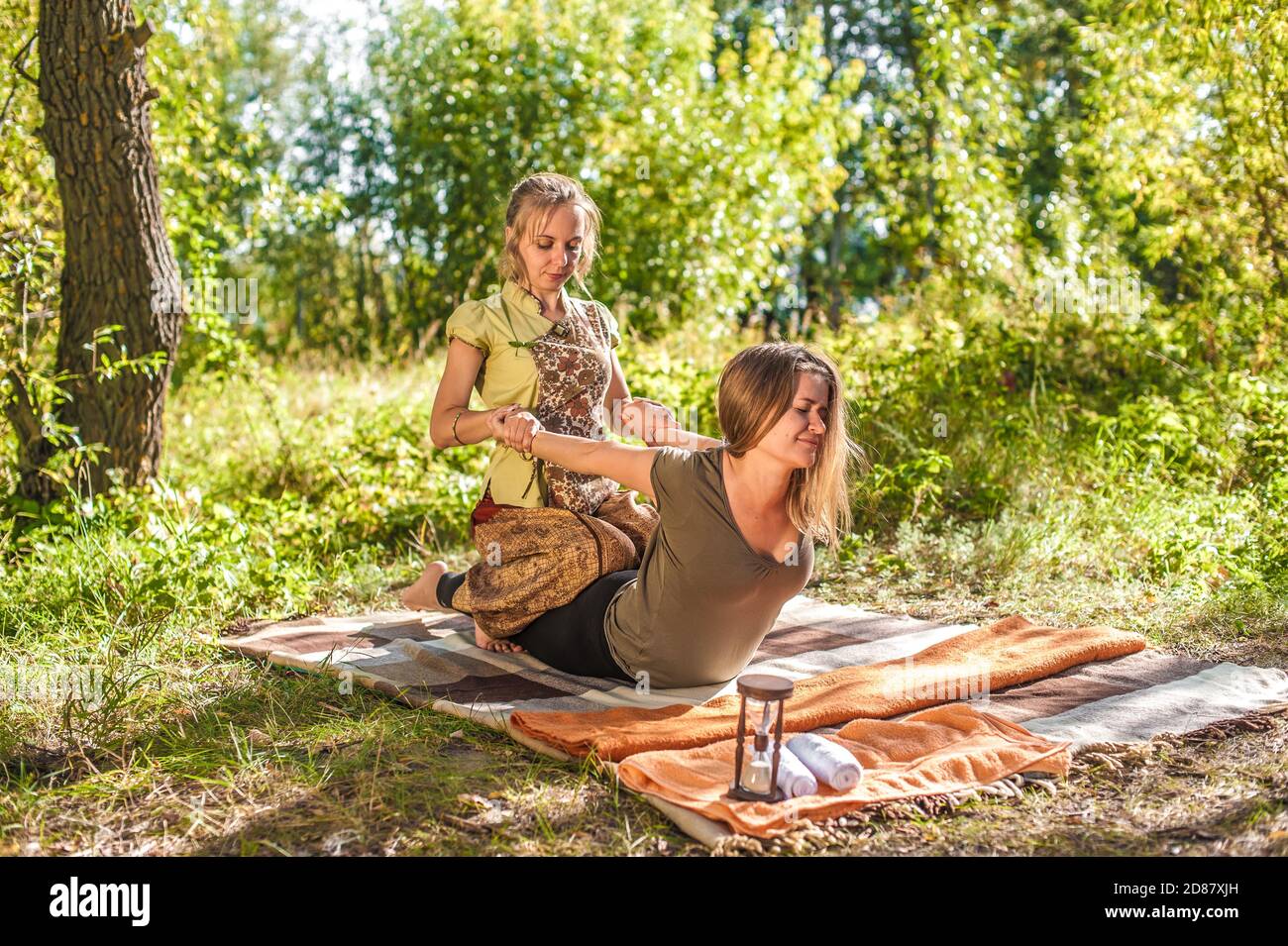 Massage Therapist Applies Her Massage Skills On Her Client On The Grass 7933