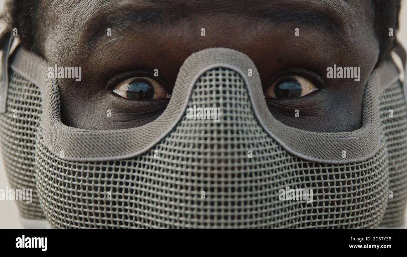 Close up, african man with mask over his face and red surprised or ...
