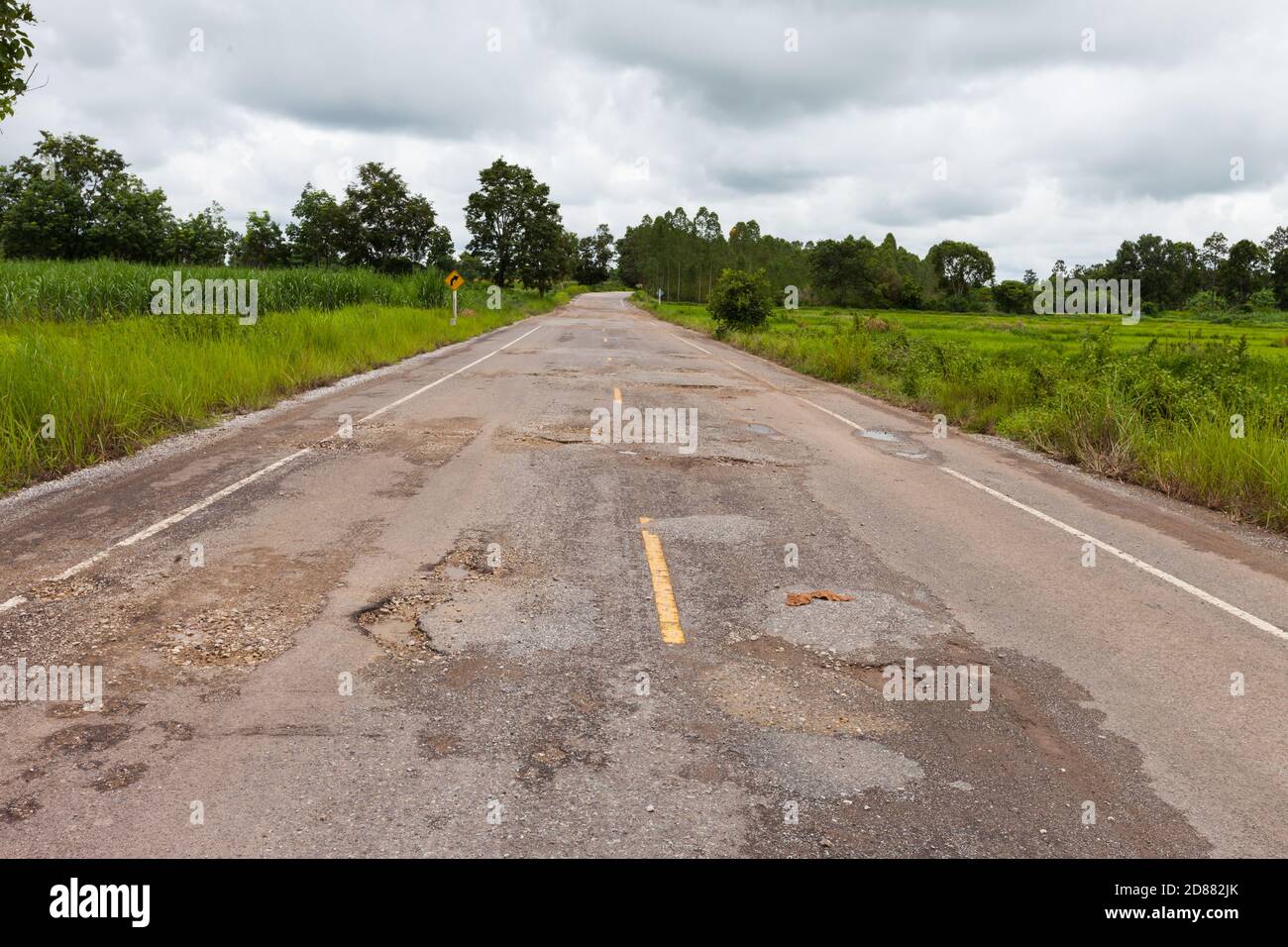 Damaged asphalt pavement road with potholes ,Asia Stock Photo - Alamy