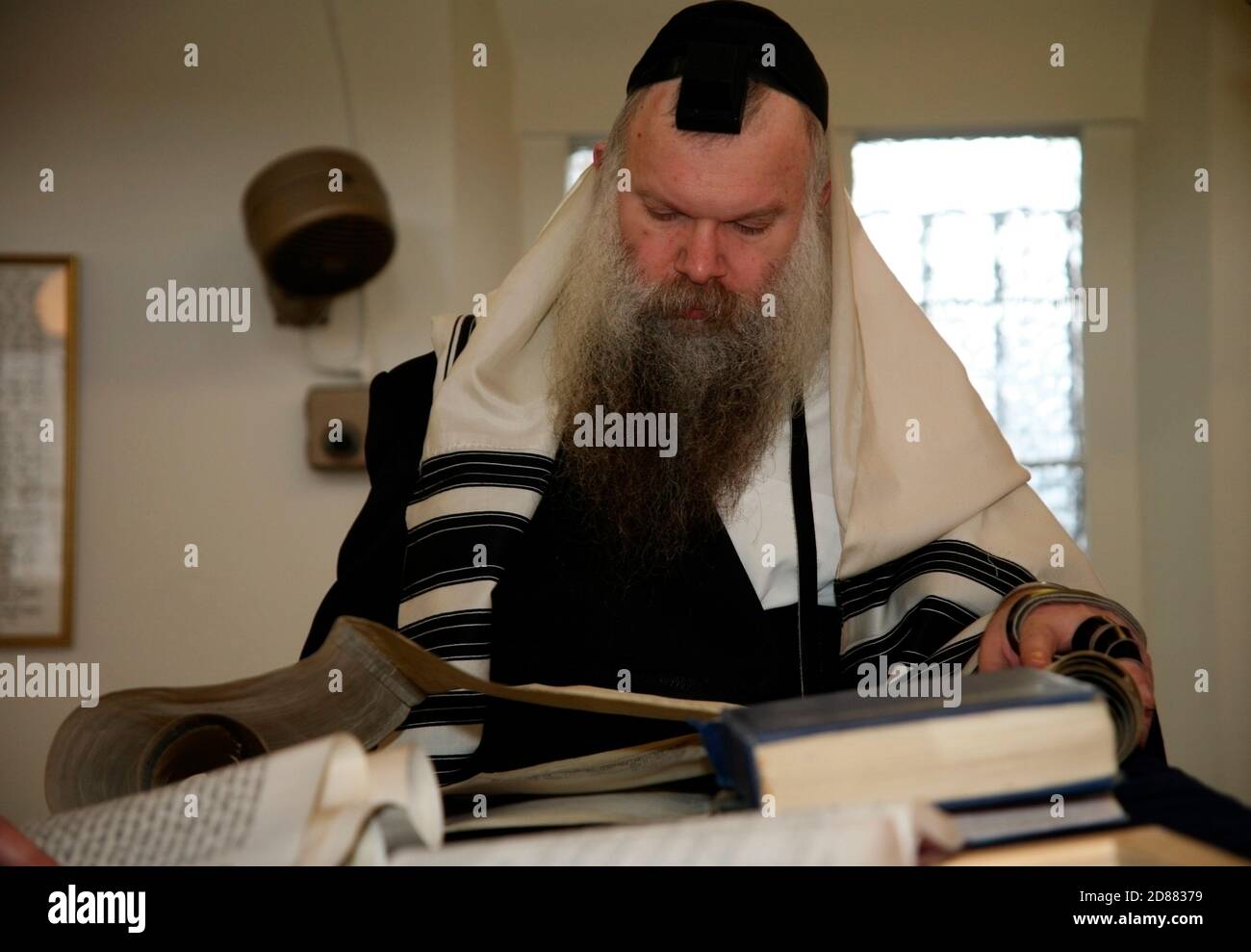 Rabbi reading from the Book of Esther in the Synagogue during Purim ...