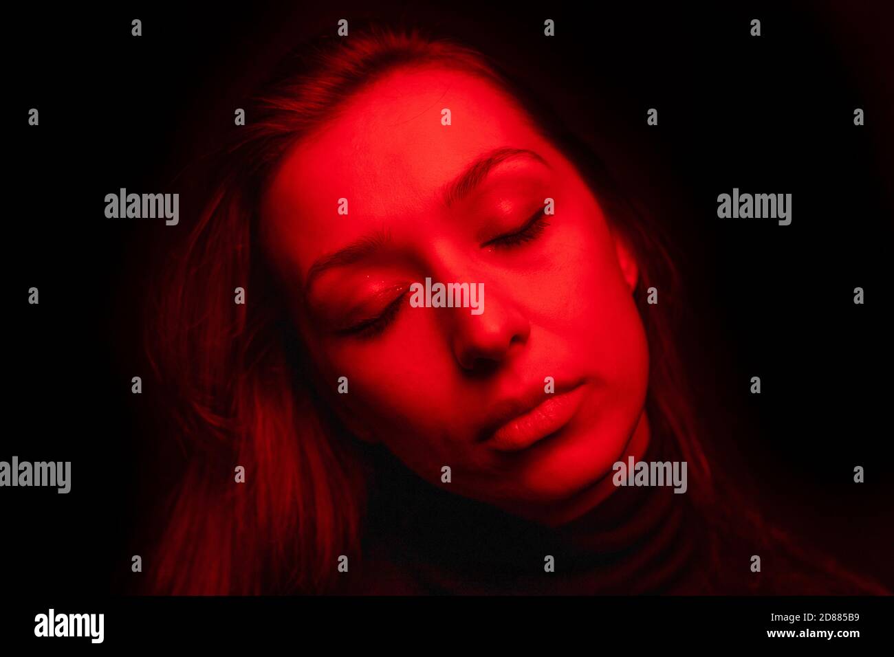 Low key full-face close up portrait of tired sleepy girl with closed ...