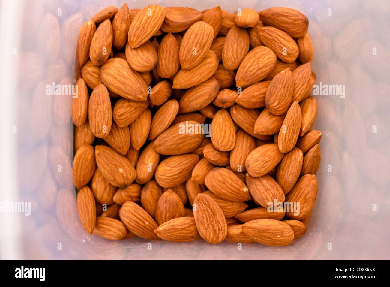 Almonds in a container from top Stock Photo - Alamy