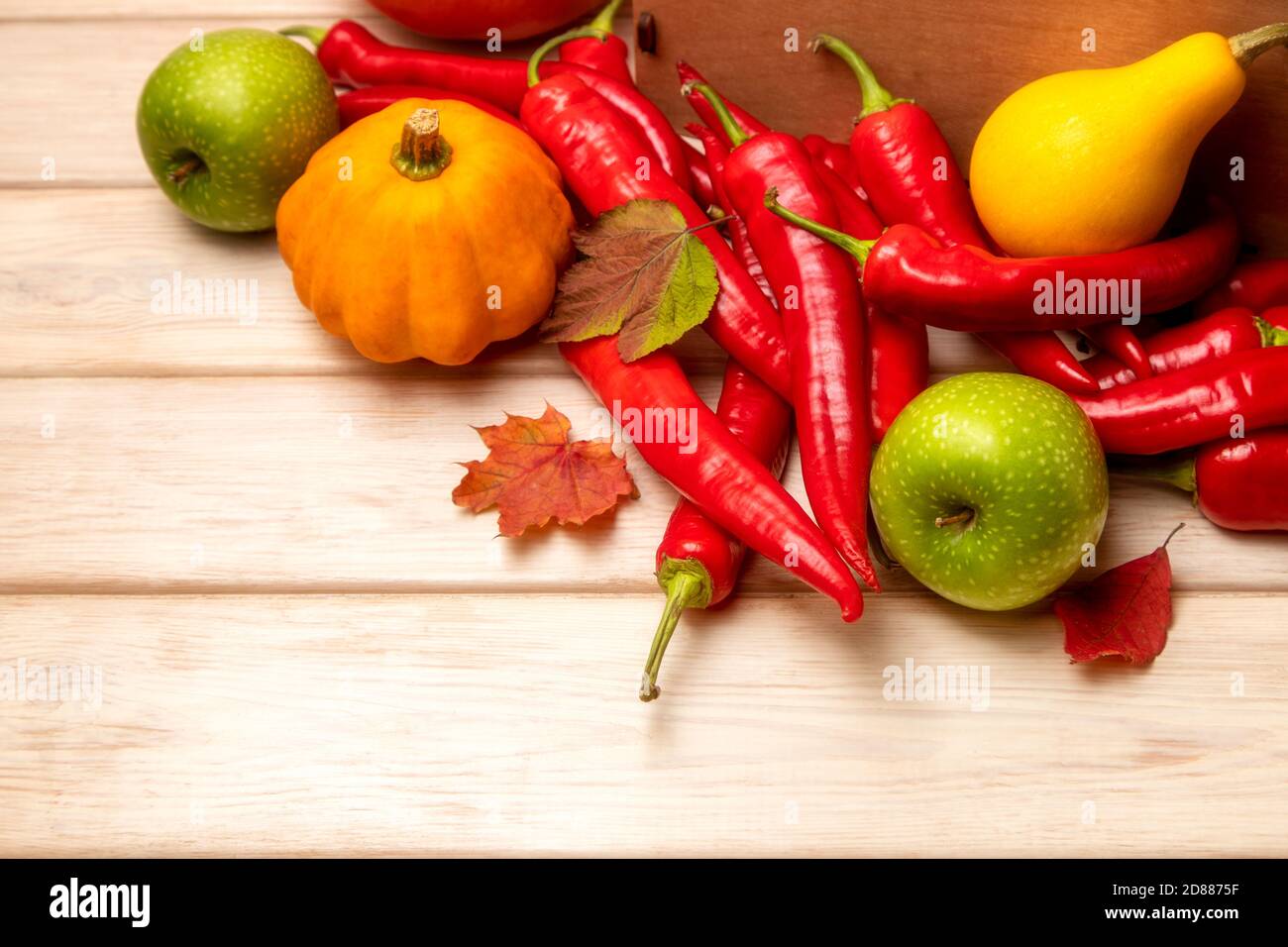 Fall background with yellow pumpkins, red hot chili peppers, green ...