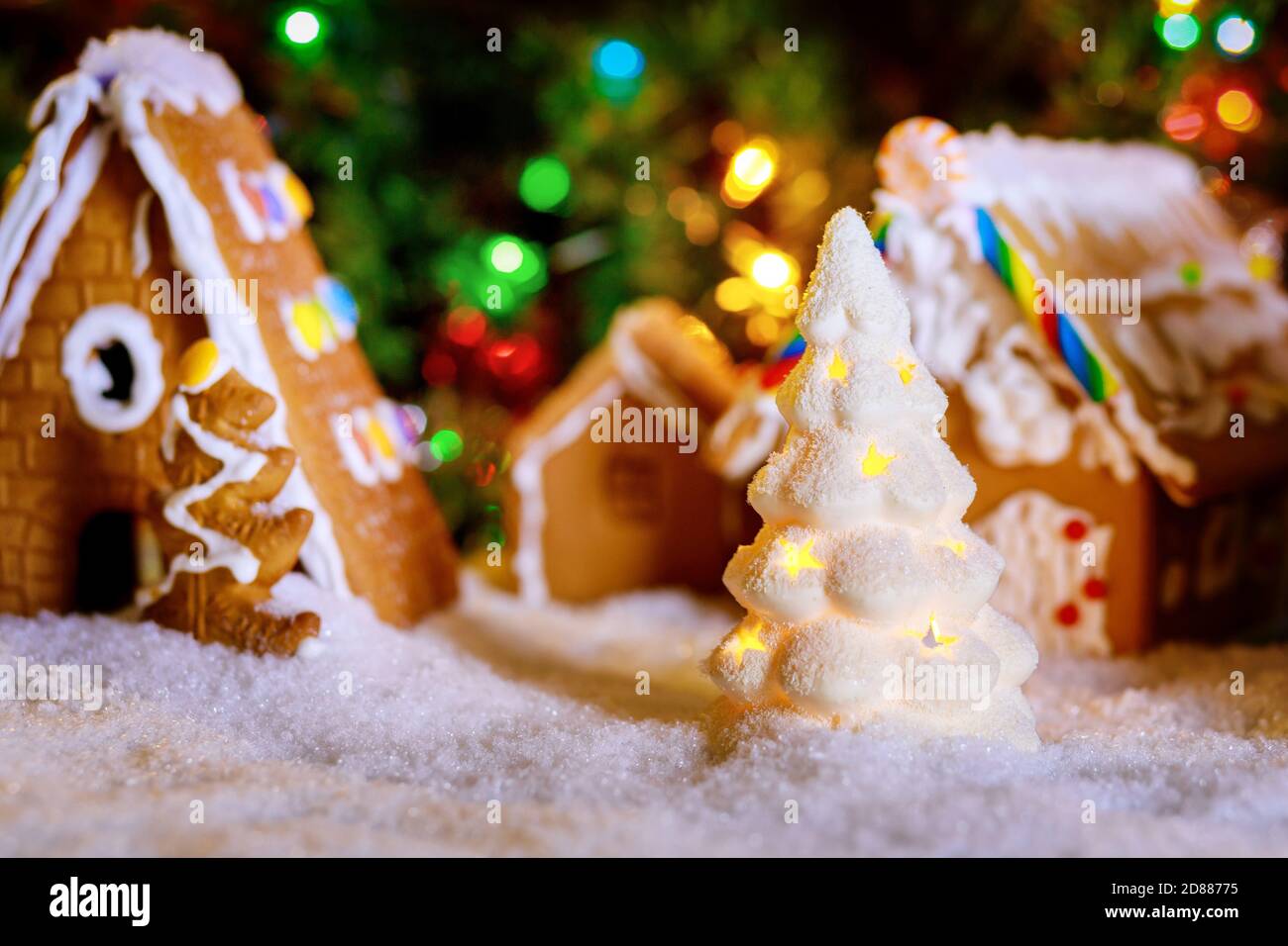 Gingerbread house and tree with lights inside. Christmas night. Soft ...