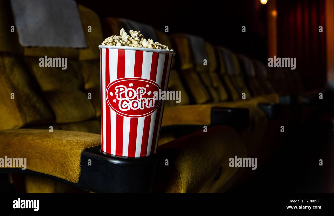 A row of yellow seat with popcorn on chair in the movie theater Stock ...