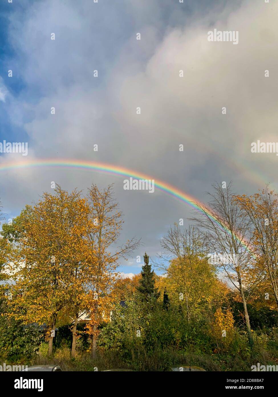 a big colorful rainbow is in the sky Stock Photo - Alamy