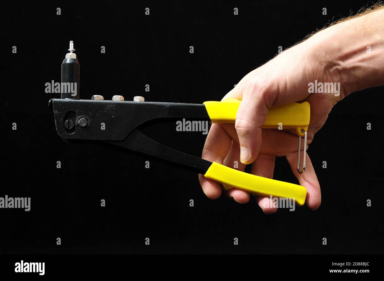 Rivets Pliers and a Hand Stock Photo - Alamy
