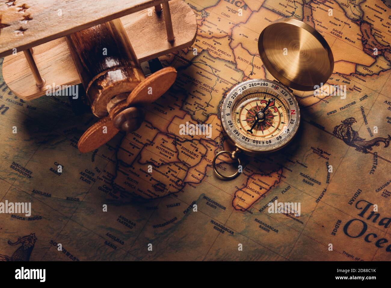 Old compass discovery and wooden plane on vintage paper antique world ...