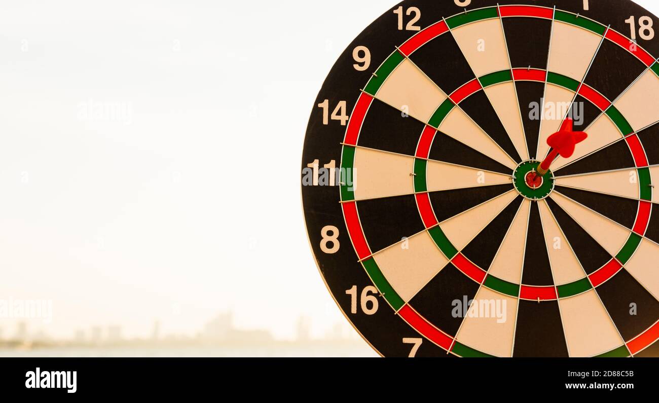 Dart arrow hitting to center on bullseye (bull's-eye) dartboard is the ... Dart arrow hitting to center on bullseye (bull's-eye) dartboard is the ...