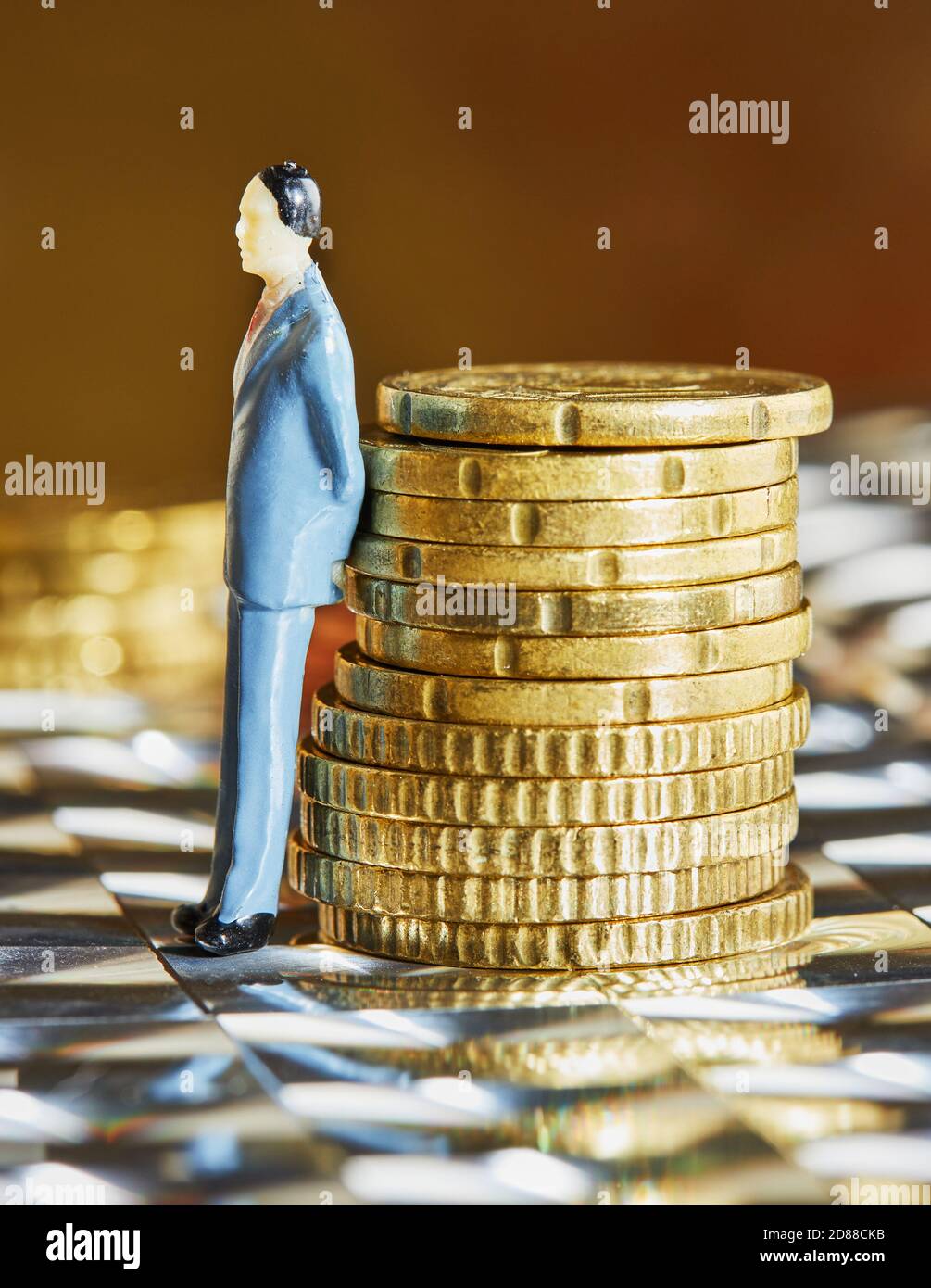 Coins stacked on top of each other with a human figure, close-up ...