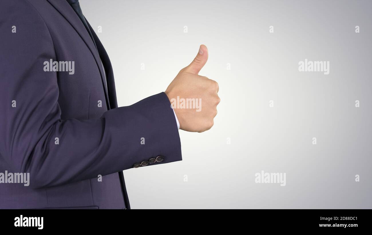 Businessman showing thumbs up on gradient background Stock Photo - Alamy