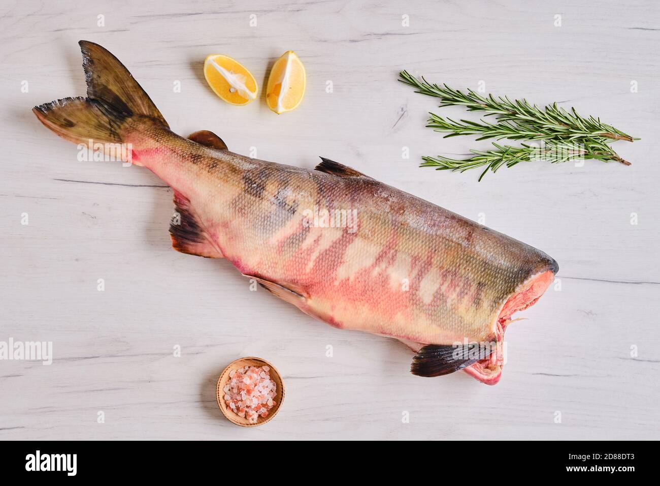 Frozen raw headless chum fish on light wooden background Stock Photo ...