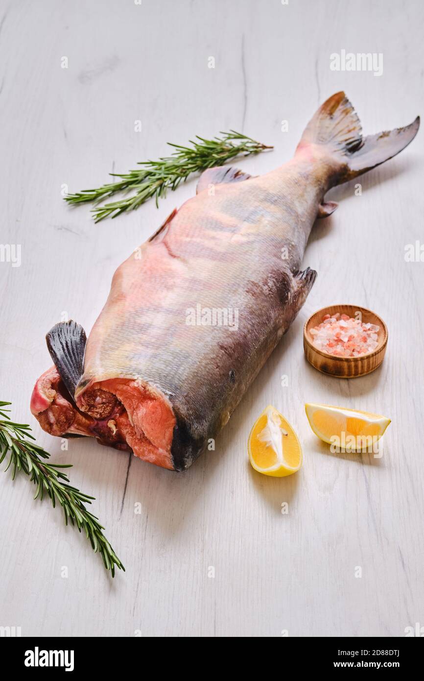 Frozen raw headless chum fish on light wooden background Stock Photo ...