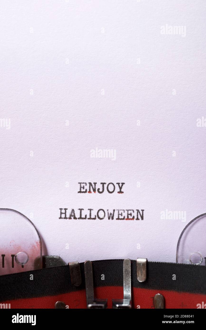 Enjoy Halloween phrase written with a typewriter Stock Photo - Alamy