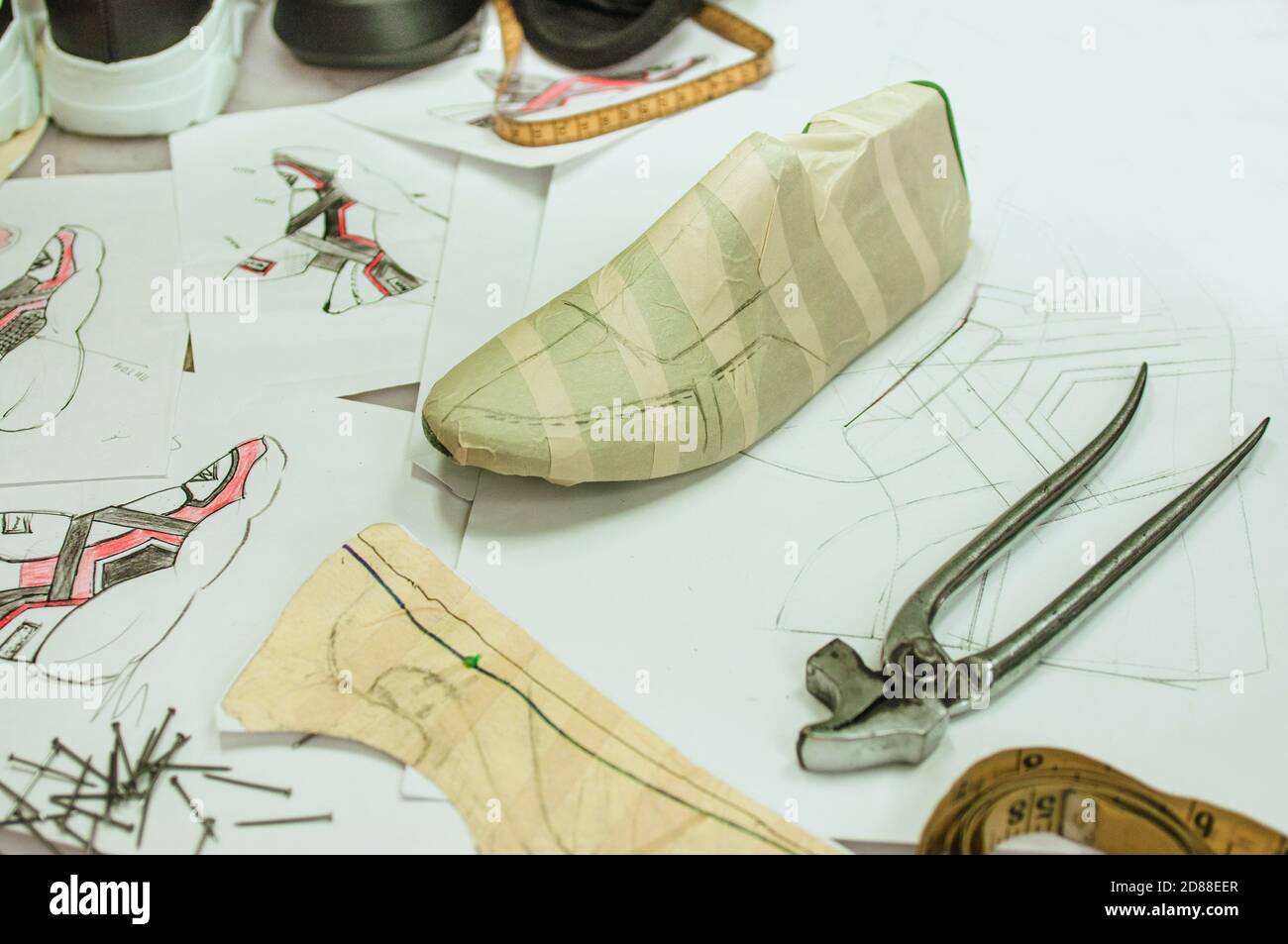 Shoe model with patterns and tools on the table Stock Photo - Alamy