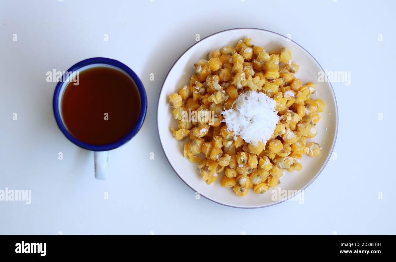 Grontol jagung and a cup of tea on white background. Grontol is ...