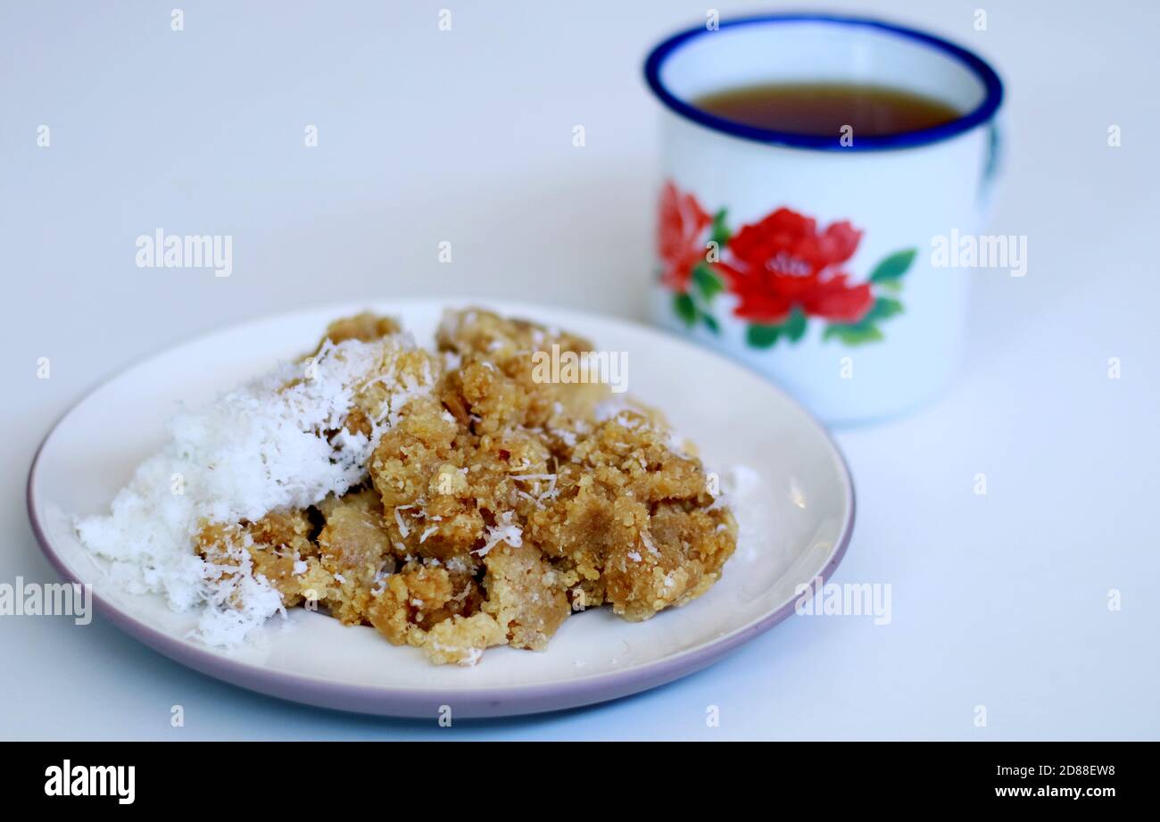 Tiwul and a cup of tea on white background. Tiwul is Indonesian ...