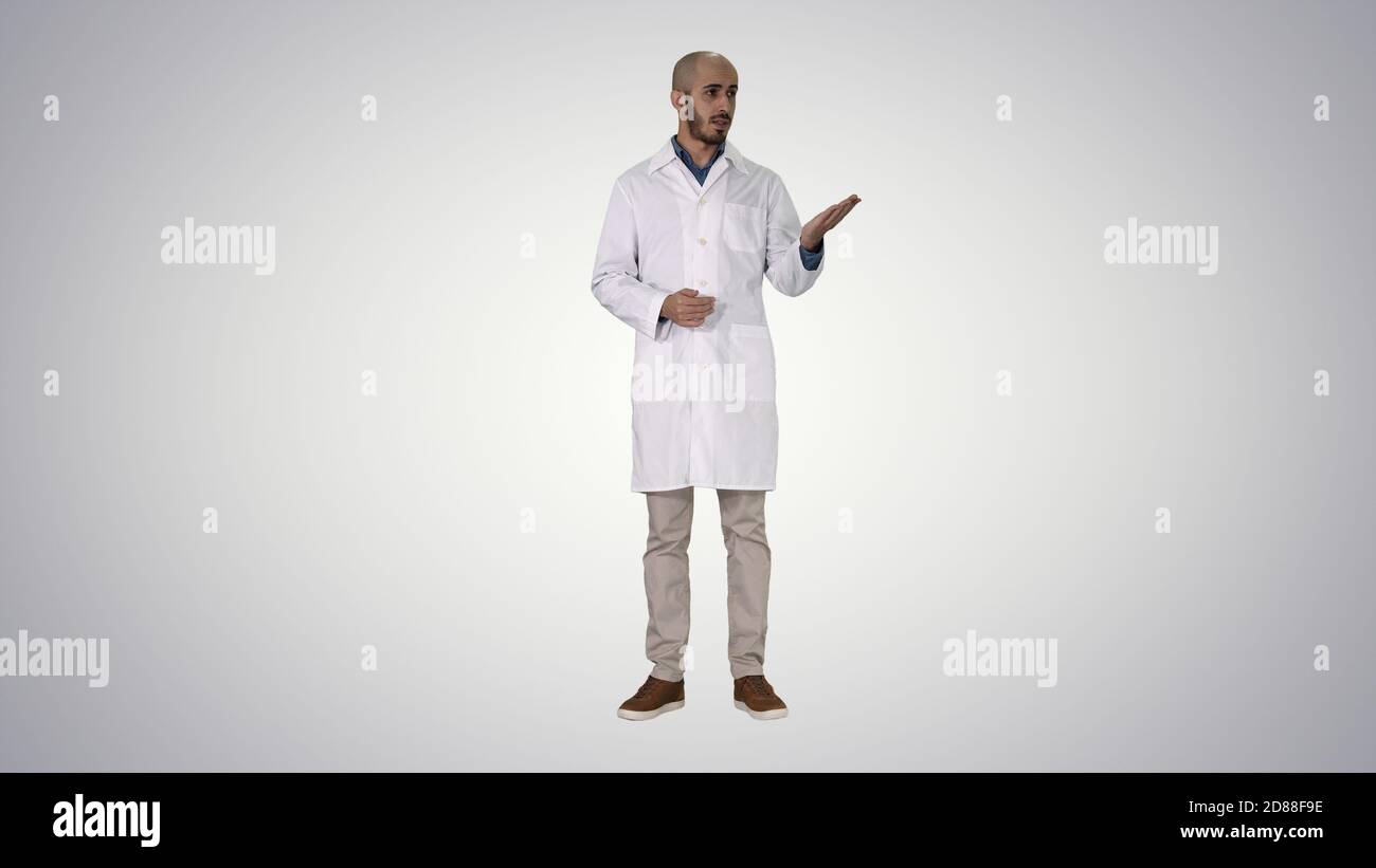 Arab doctor man in medical coat talking and presenting with hand Stock ...