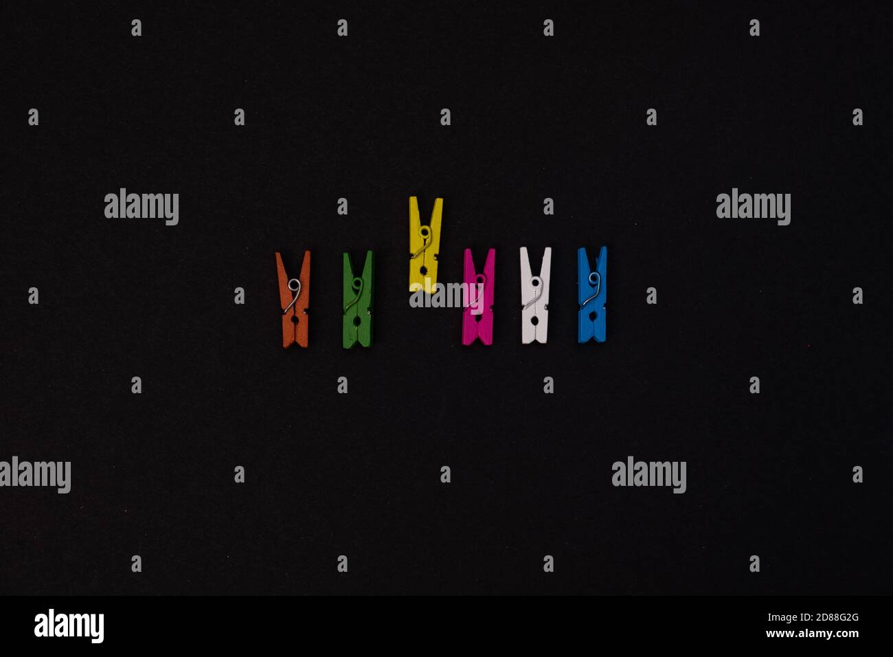 One peg standing out from the crowd, different colors, leadership ...