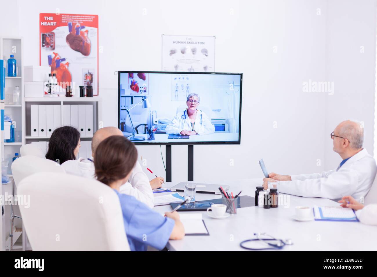 Team of medical staff during video conference with doctor in hospital ...