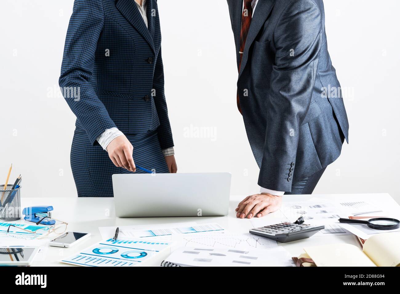 Businesspersons stand near office desk Stock Photo - Alamy