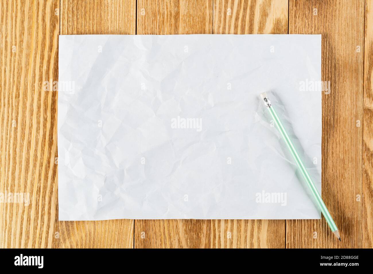 Sheet of paper lying on wooden table Stock Photo - Alamy