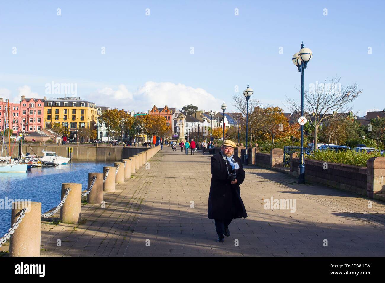 11 July 2019 Pedestrians stroll the promenade at the seafront marina in ...