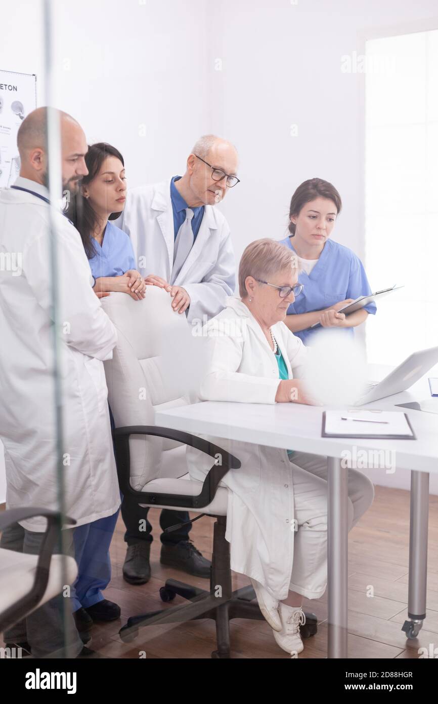 Medical team having a discussion about patient diagnosis looking at ...