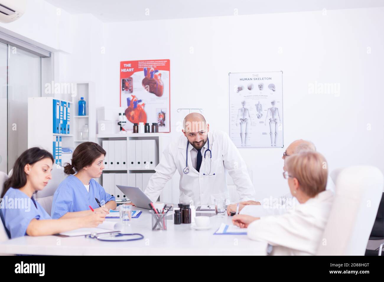 Doctor having professional discussion with medical staff in hospital ...