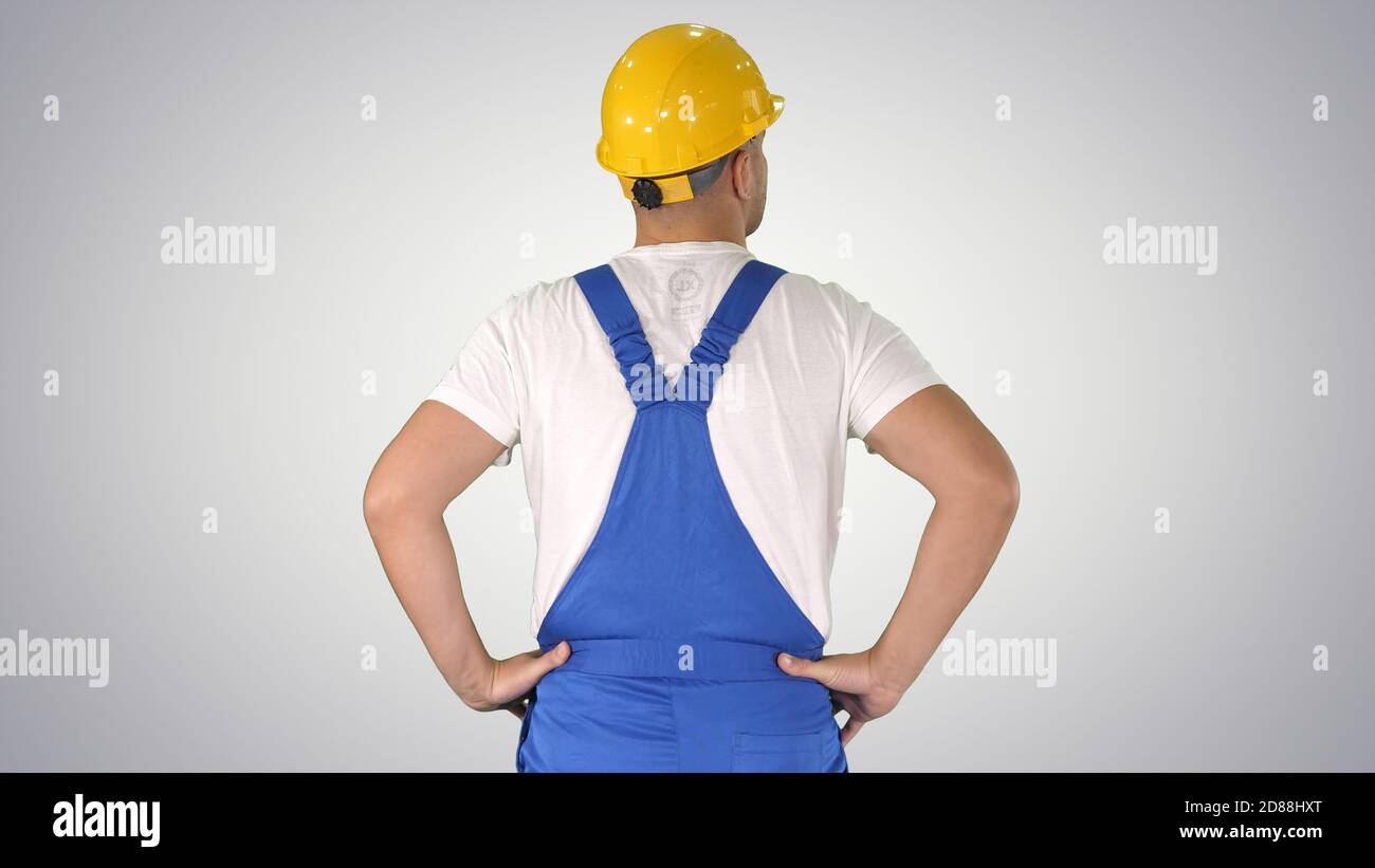 Engineer in construction helmet standing with hands on hips look Stock ...