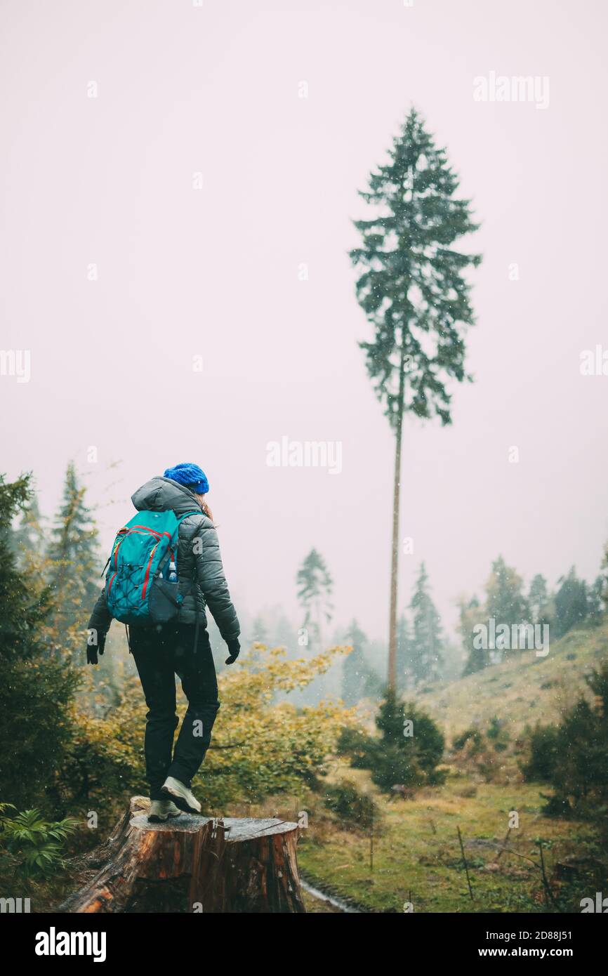 Woman Jumping On Stump In Woods. Back View Stock Photo - Alamy