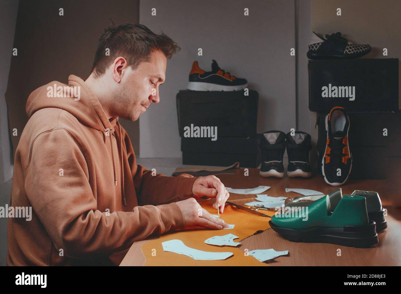 Shoemaker drawing a pattern on the shoe model Stock Photo - Alamy