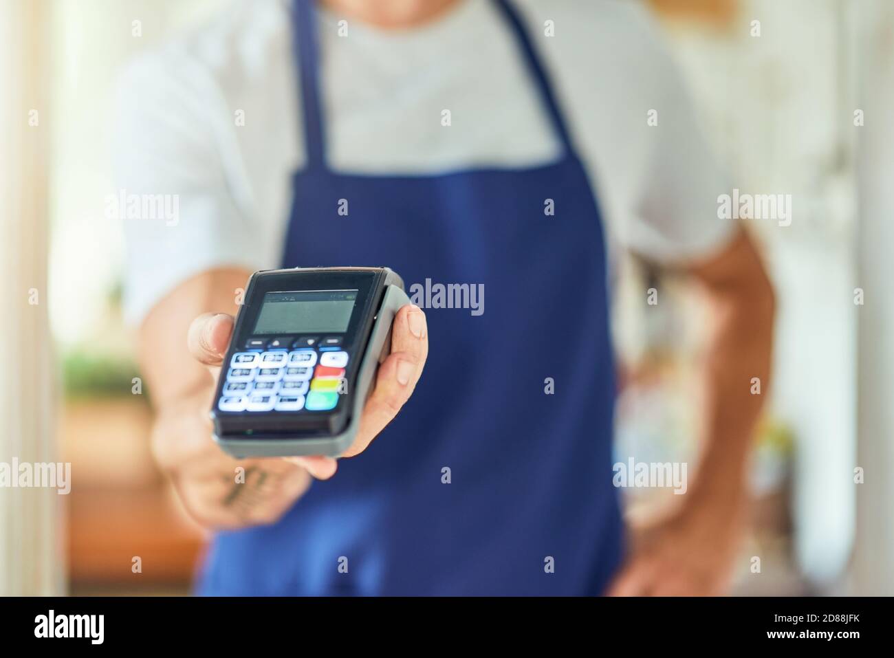 Paying terminal in businessman hand Stock Photo - Alamy