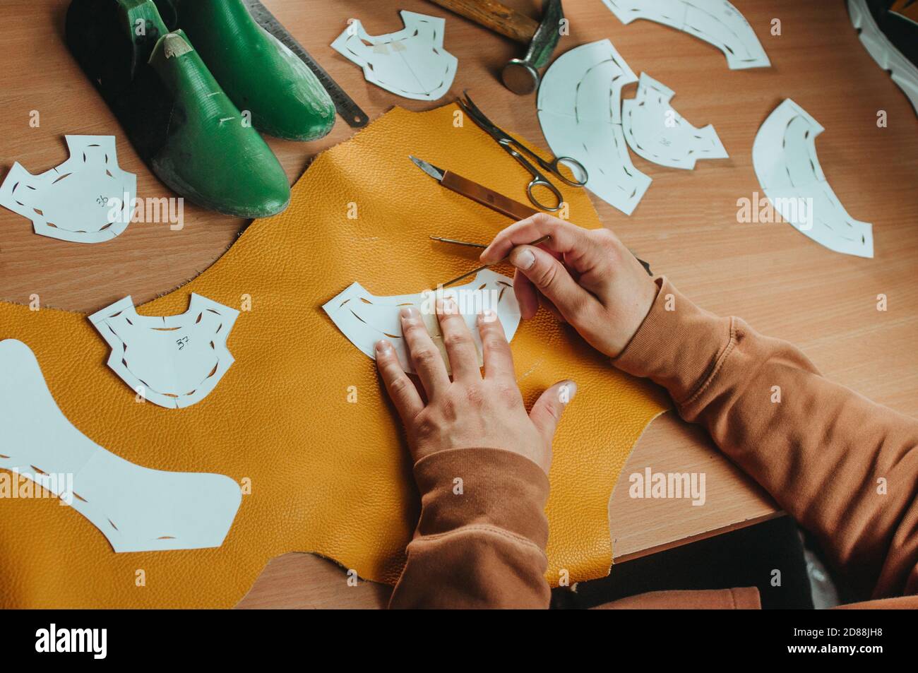 Shoemaker at work making pattern of future shoes Stock Photo - Alamy