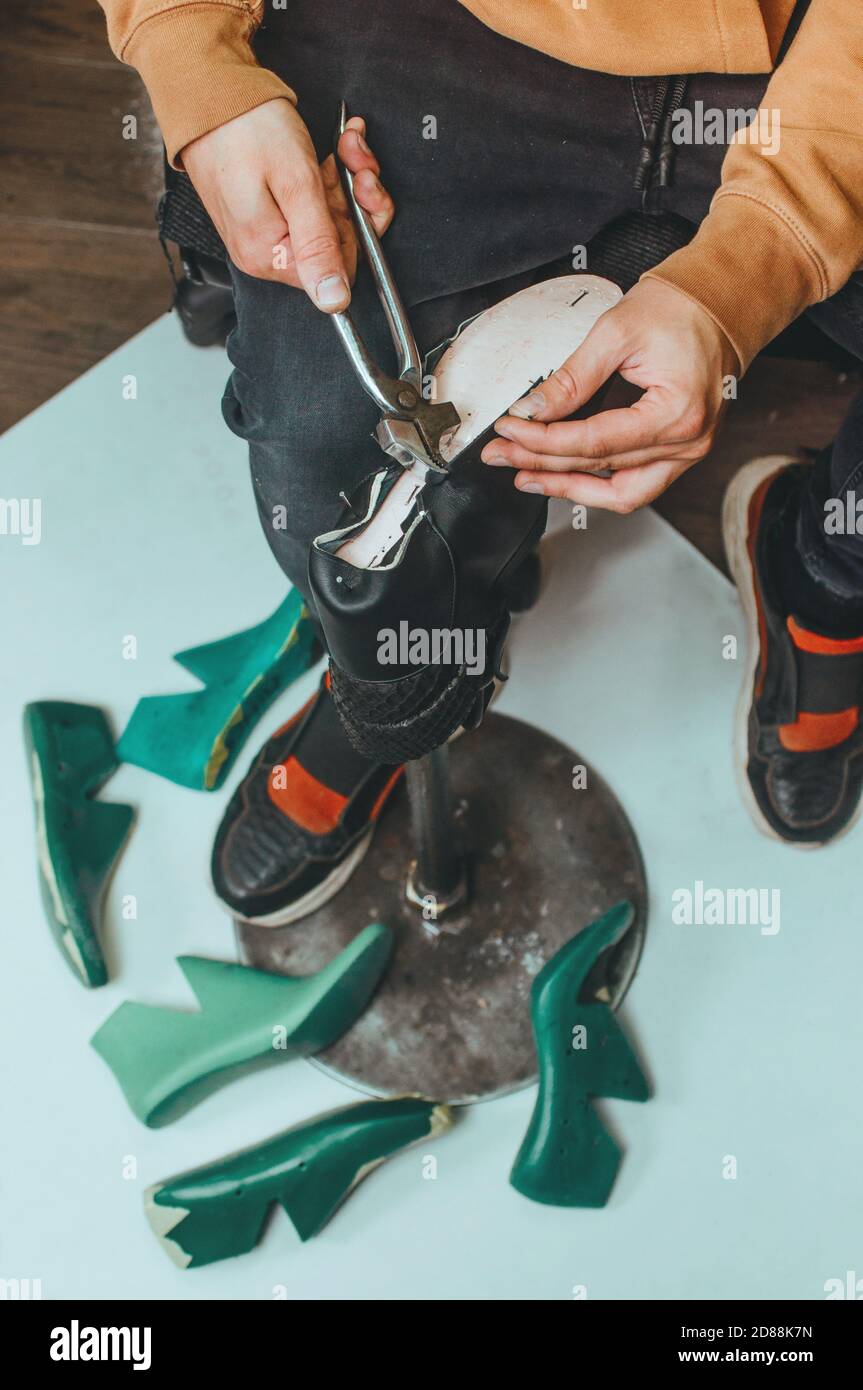 Close up of shoemaker making shoe using shoemaker tools Stock Photo - Alamy