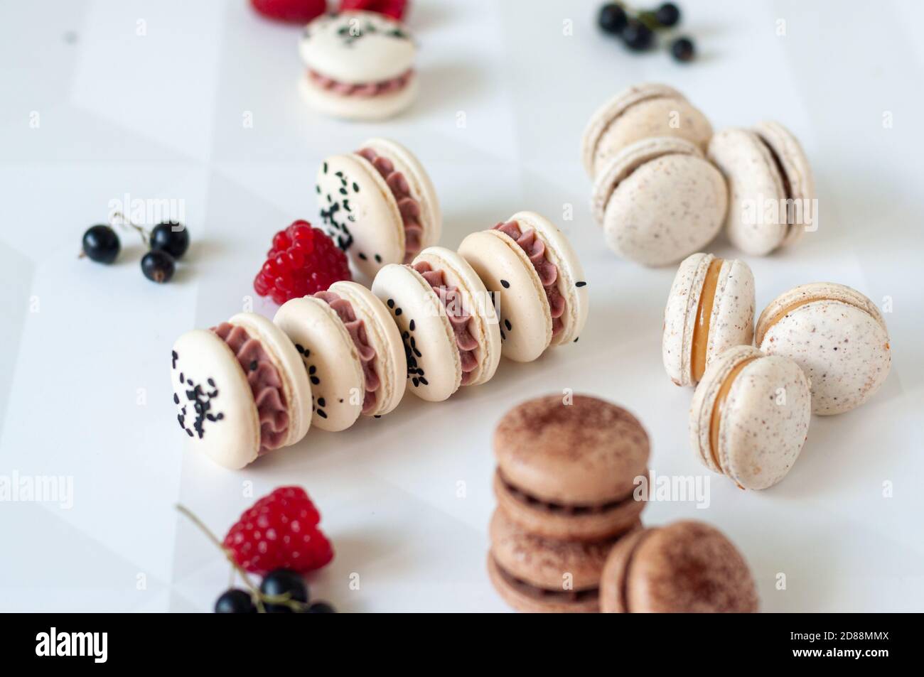 Macarons and berries on white table Stock Photo - Alamy