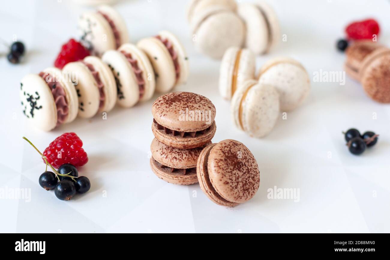 Macarons and berries on white table Stock Photo - Alamy
