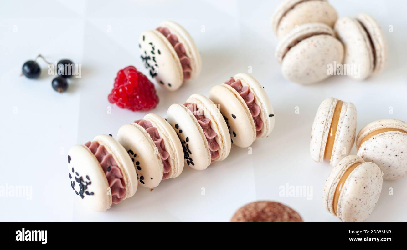 Macarons and berries on white table Stock Photo - Alamy