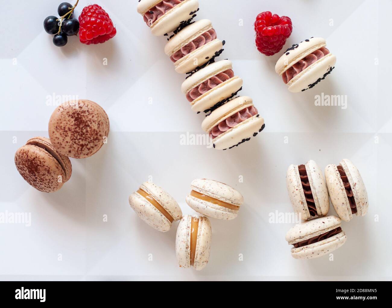 Macarons and berries on white table Stock Photo - Alamy
