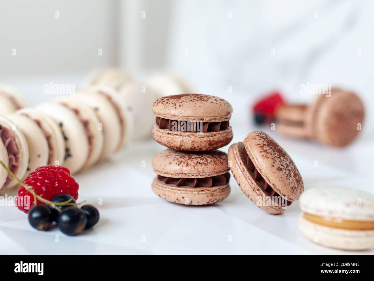 Macarons and berries on white table Stock Photo - Alamy