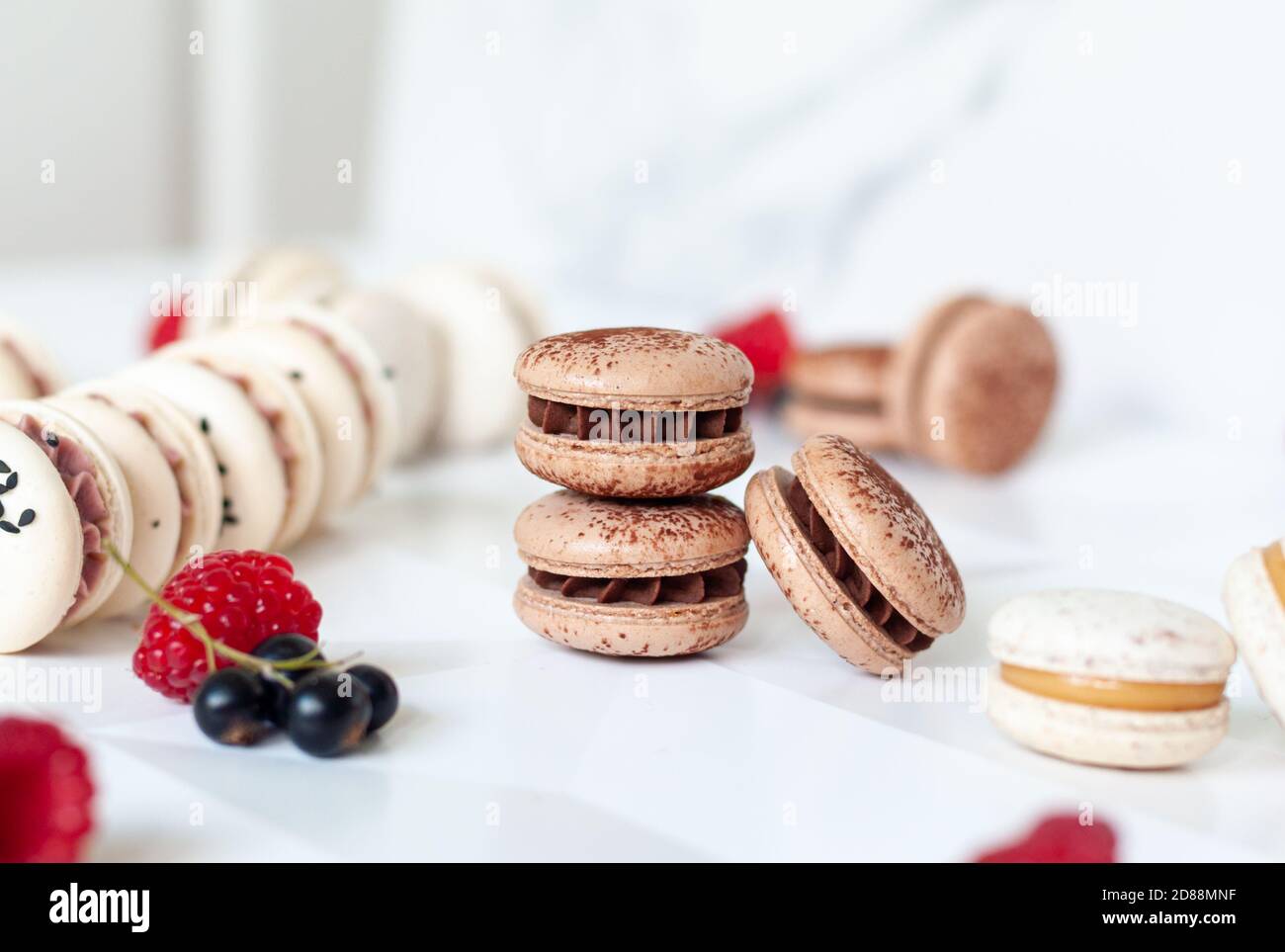 Macarons and berries on white table Stock Photo - Alamy