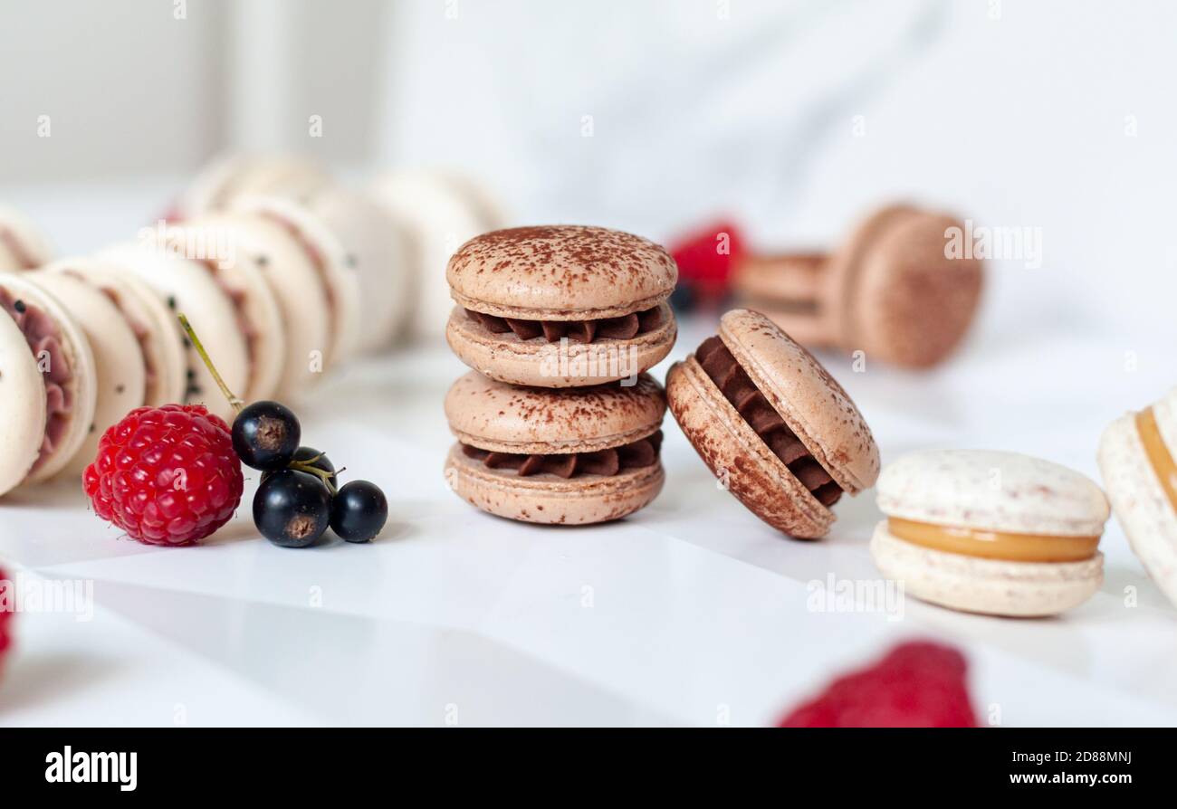 Macarons and berries on white table Stock Photo - Alamy