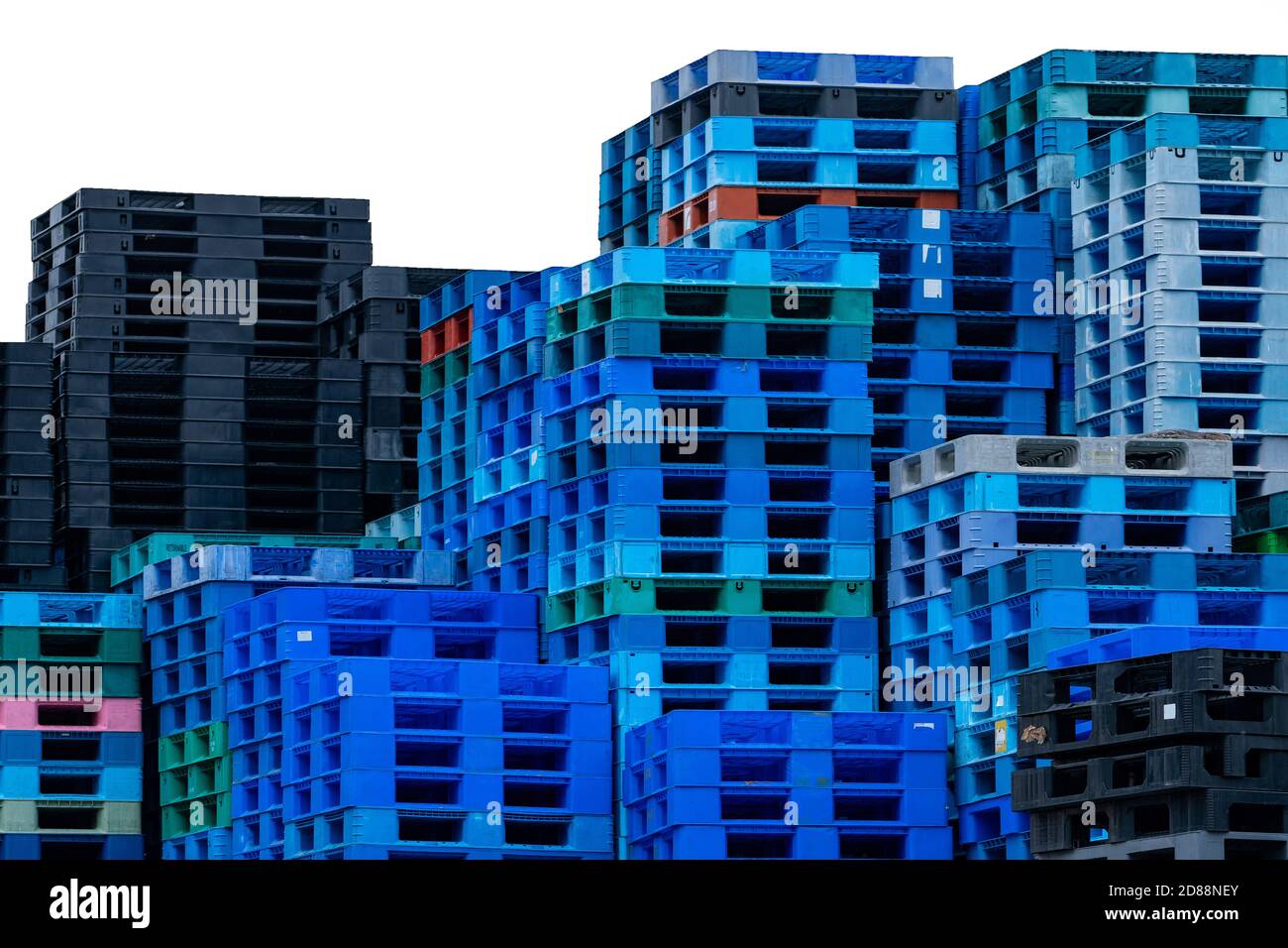 Pile of plastic shipping pallet isolated on white. Industrial plastic ...