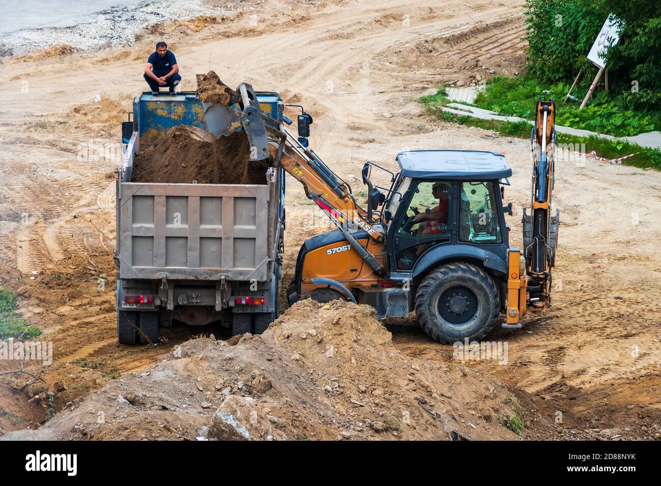 Russia, Kaluga - OCTOBER 27, 2020: Tractor carrying soil with a bucket ...
