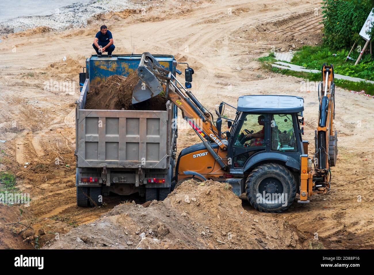 Russia, Kaluga - OCTOBER 27, 2020: Tractor carrying soil with a bucket ...