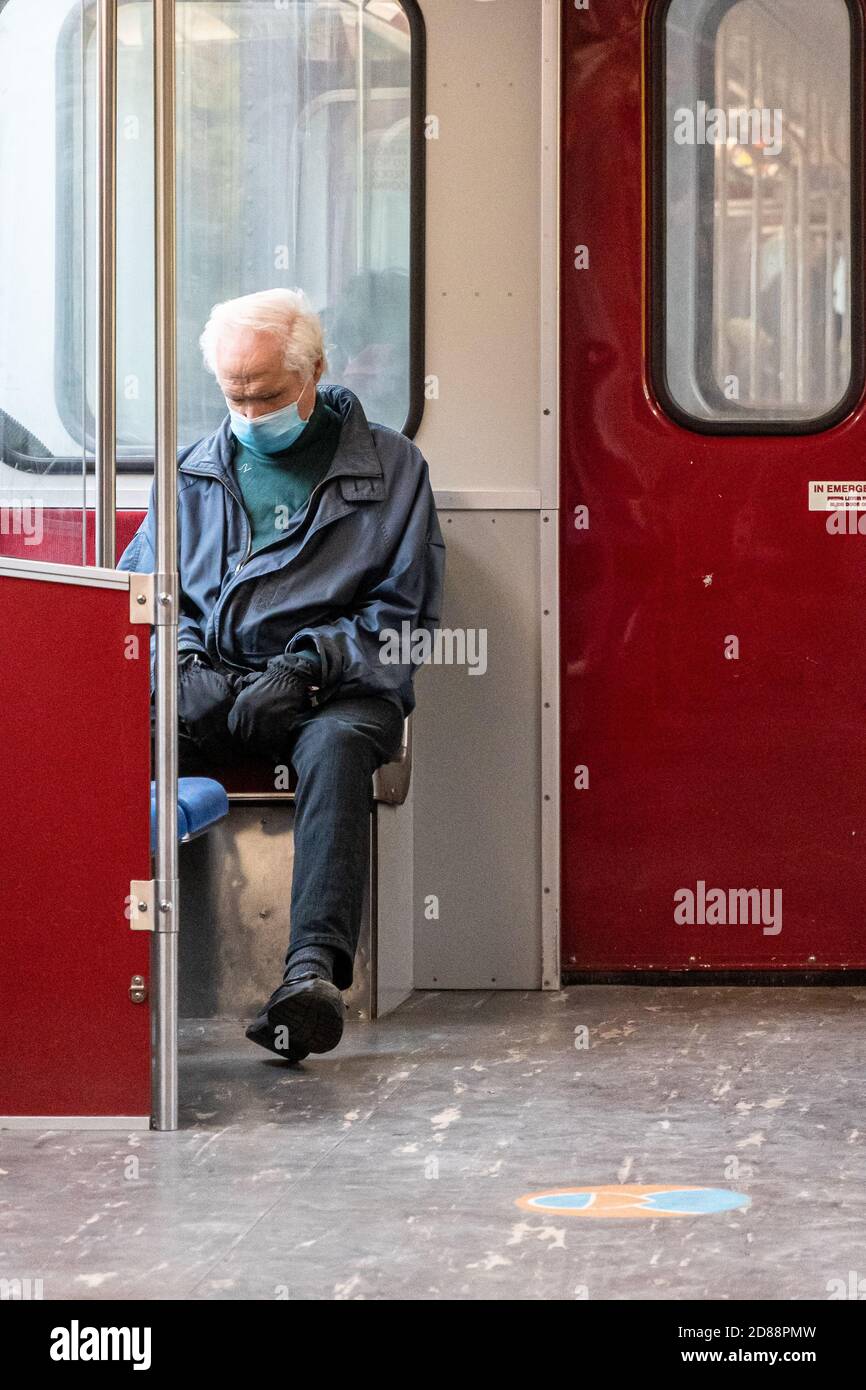 People wearing protective face masks while riding the TTC. Masks are ...